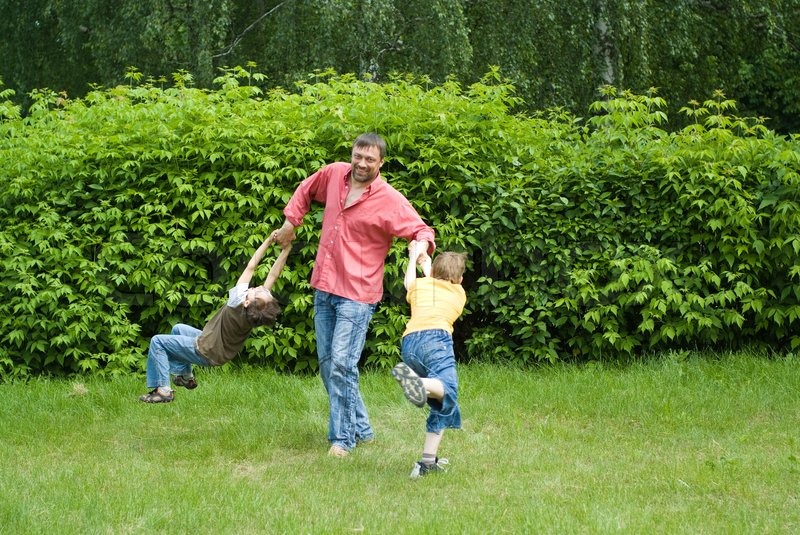 Dad plays with young children | Stock image | Colourbox