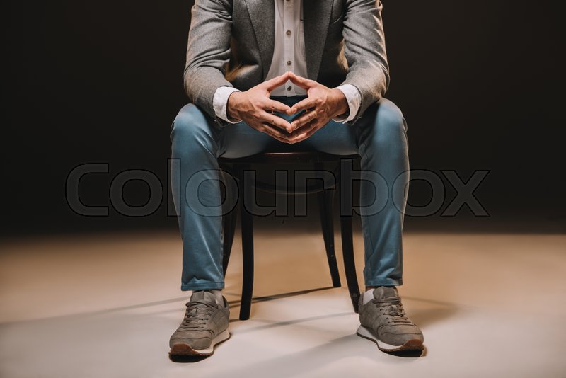 Cropped view of stylish man sitting on ... | Stock image | Colourbox