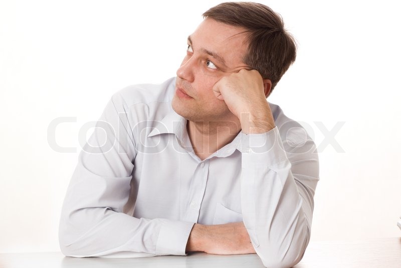 Man sitting pensively on a white ... | Stock image | Colourbox