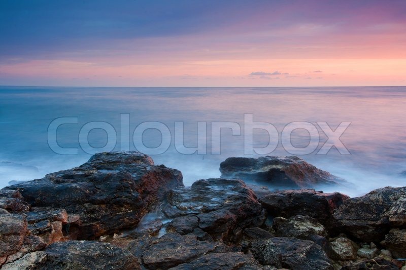 Beautiful rocky sea beach at the sunset | Stock image | Colourbox