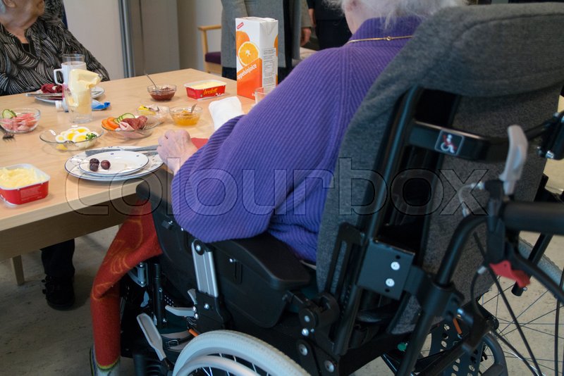 Disabled person having breakfast at the ... | Stock image | Colourbox
