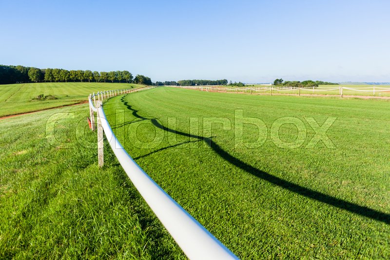 Green grass horse race track railing ... | Stock image | Colourbox