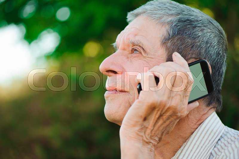 Grandfather with mobile phone in a ... | Stock image | Colourbox