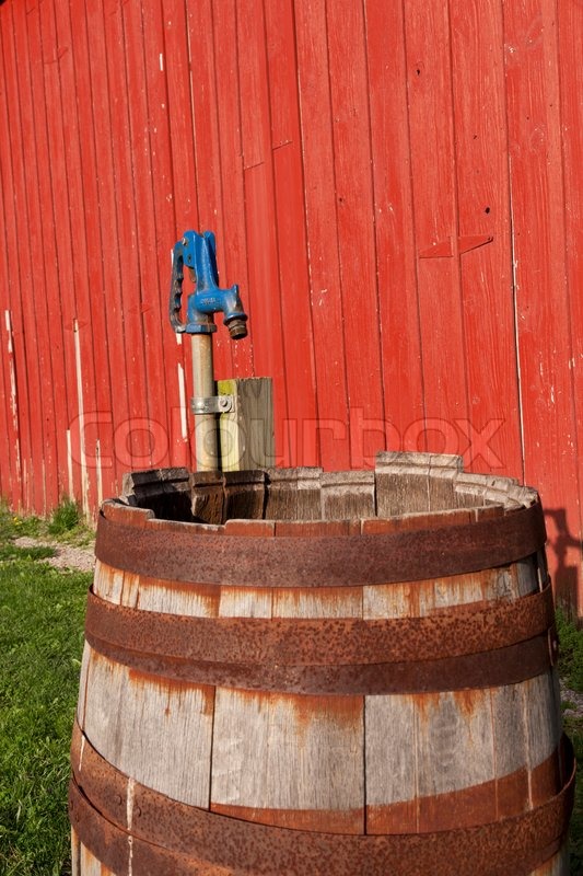 Old wooden barrel beside a red barn | Stock image | Colourbox