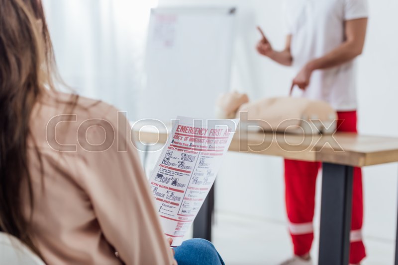 Back view of woman holding first aid ... | Stock image | Colourbox