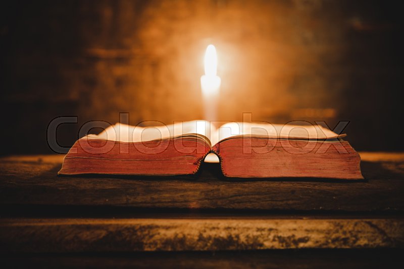 Open Holy Bible and candle on a old oak ... | Stock image | Colourbox
