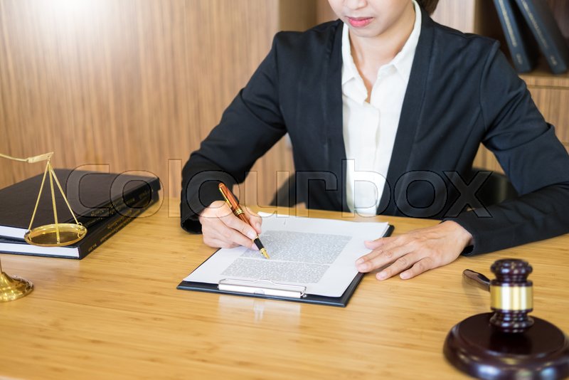 Lawyer judge reading documents at desk ... | Stock image | Colourbox