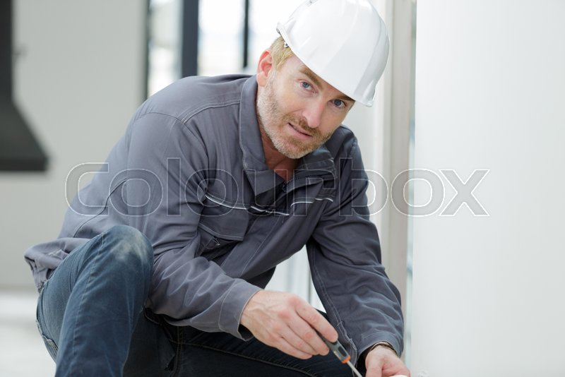 Man builder with construction tools | Stock image | Colourbox
