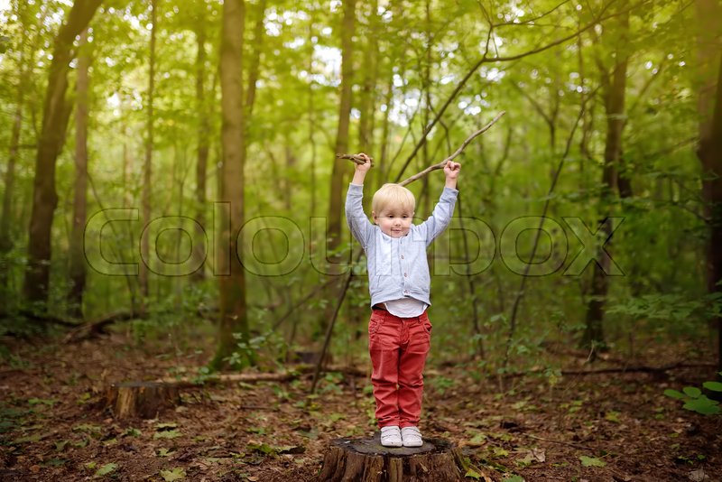 Little boy playing with sticks on ... | Stock image | Colourbox