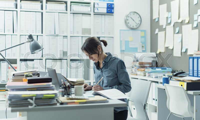 Efficient female office clerk sitting ... | Stock image | Colourbox