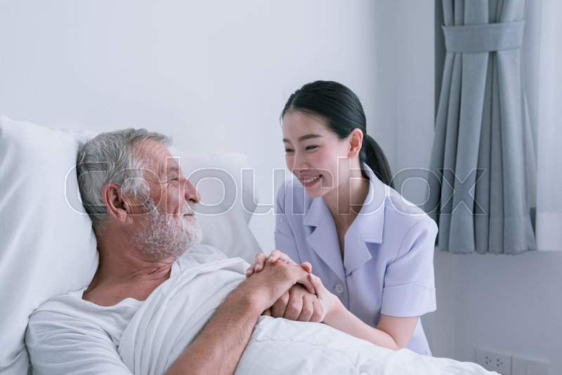 Senior man with smiling nurse, takes ... | Stock image | Colourbox