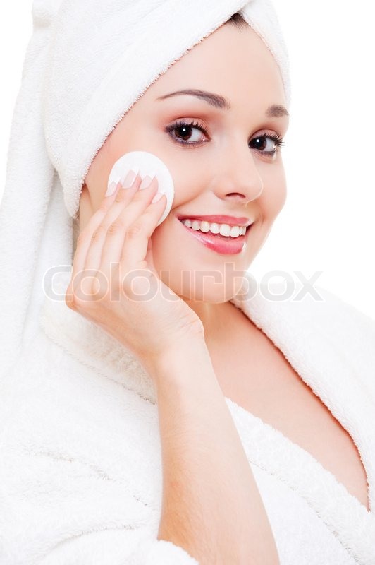 Pretty young woman cleaning her face ... | Stock image | Colourbox