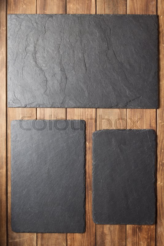 Slate stone sign board at wooden plank, ... | Stock image | Colourbox