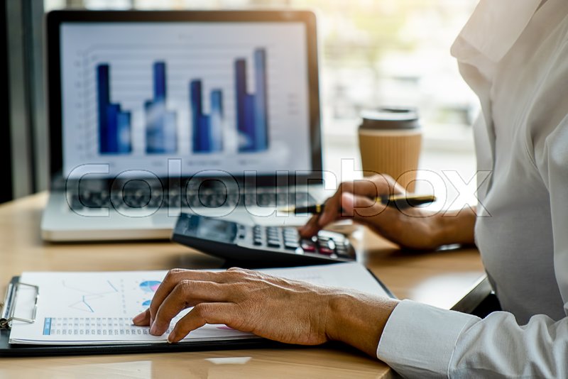 Business adviser analyzing financial ... | Stock image | Colourbox