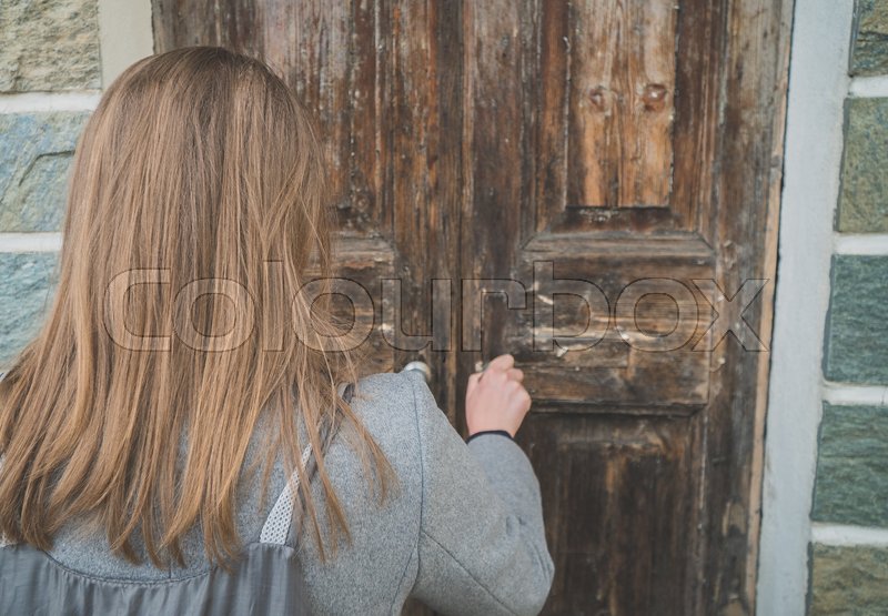 Woman opening very old wooden door in ... | Stock image | Colourbox