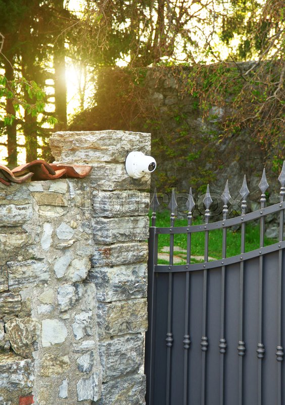 Metal gates and security camera. ... | Stock image | Colourbox