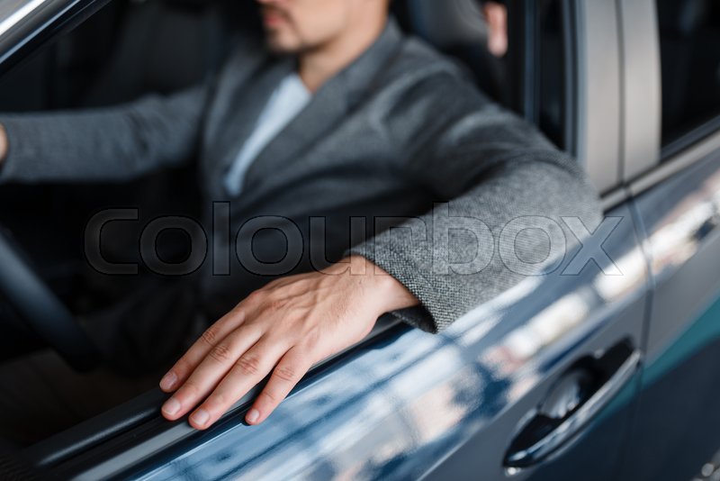 Male person sitting in new car, ... | Stock image | Colourbox