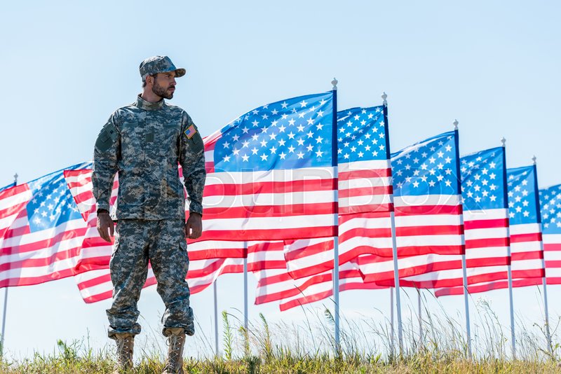 Patriotic soldier in uniform standing ... | Stock image | Colourbox