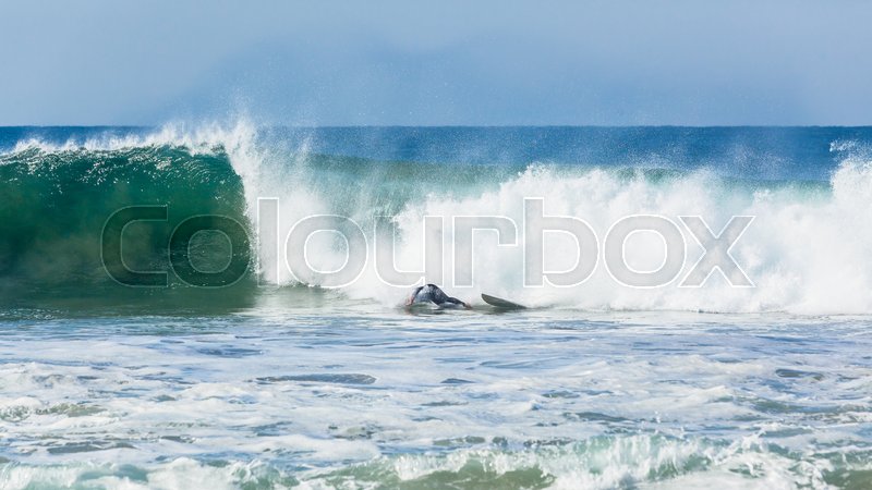 Surfer surfing ride crashing wipeout ... | Stock image | Colourbox