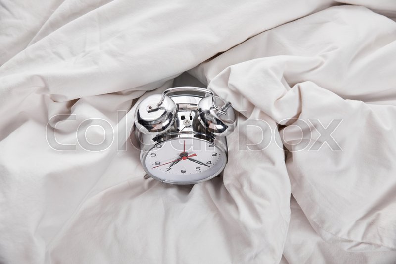 Top view of silver alarm clock in white ... | Stock image | Colourbox