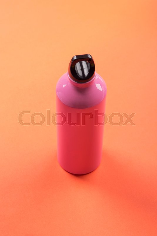 Pink trendy thermos bottle on orange ... | Stock image | Colourbox