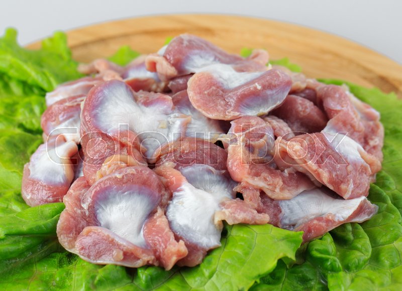 Raw chicken gizzards on a white ... | Stock image | Colourbox