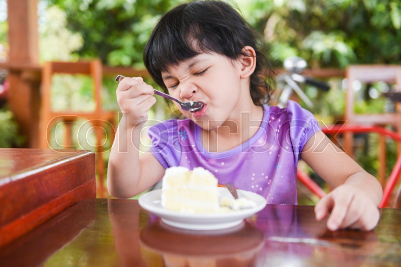 Little Girl Eating Cake