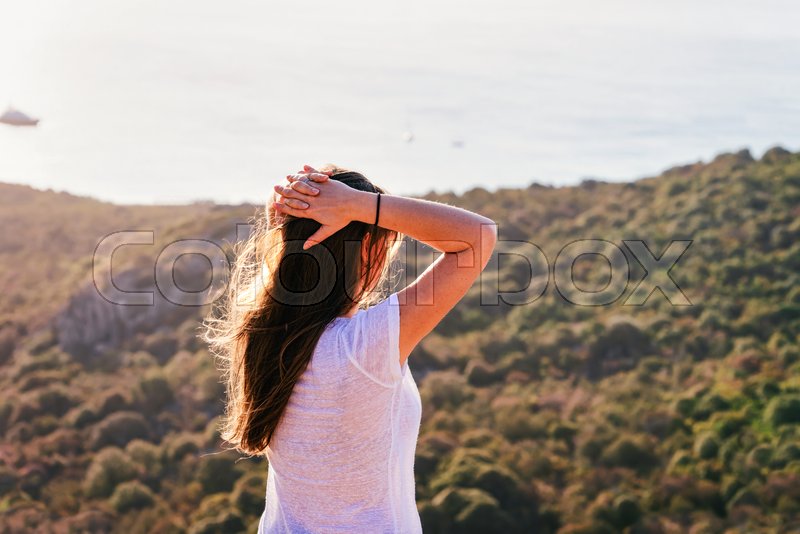 Sunrise or sunset and young girl at ... | Stock image | Colourbox