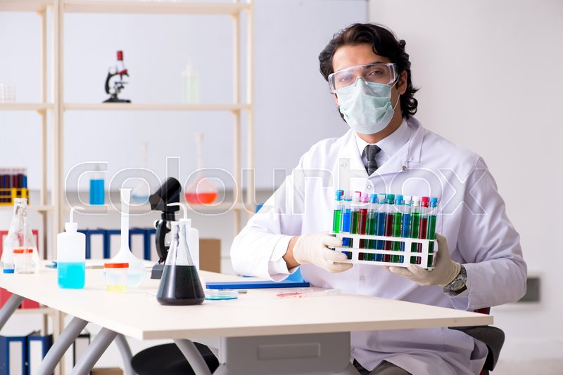 The young handsome chemist working in ... | Stock image | Colourbox
