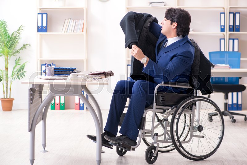 Young male employee in wheelchair ... | Stock image | Colourbox