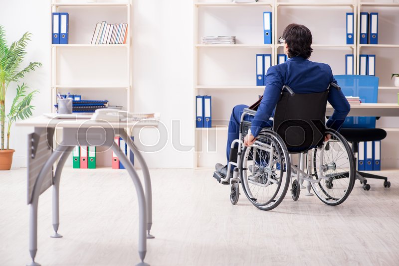 Young male employee in wheelchair ... | Stock image | Colourbox