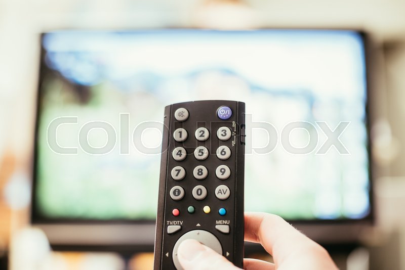 TV remote control in the foreground, tv ... | Stock image | Colourbox