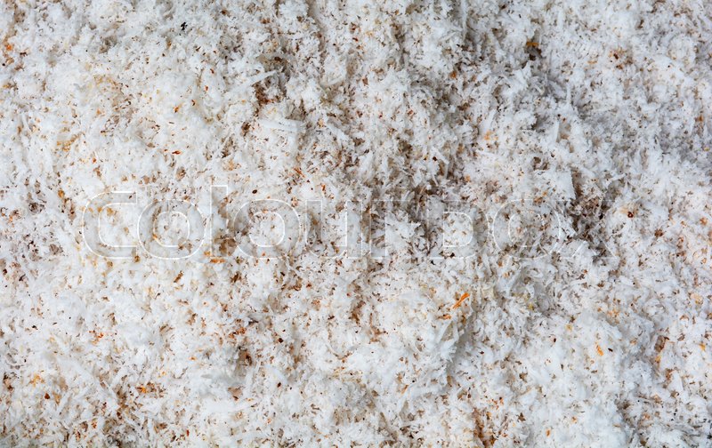 Shredded coconut scraping out of fresh ... | Stock image | Colourbox