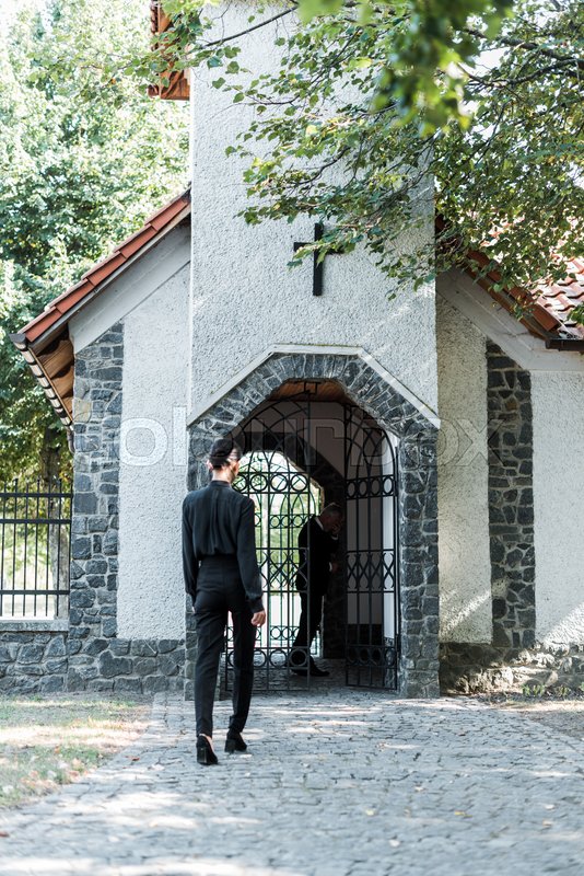 Back view of woman walking into church ... | Stock image | Colourbox