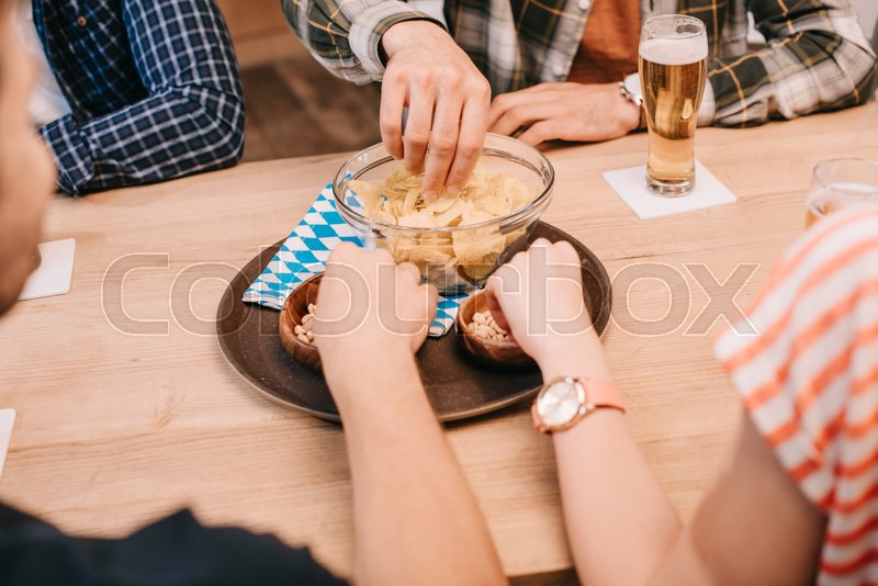 Partial view of friends taking snacks ... | Stock image | Colourbox