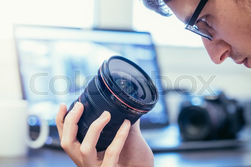 Male photographer has a lens in his ... | Stock image | Colourbox