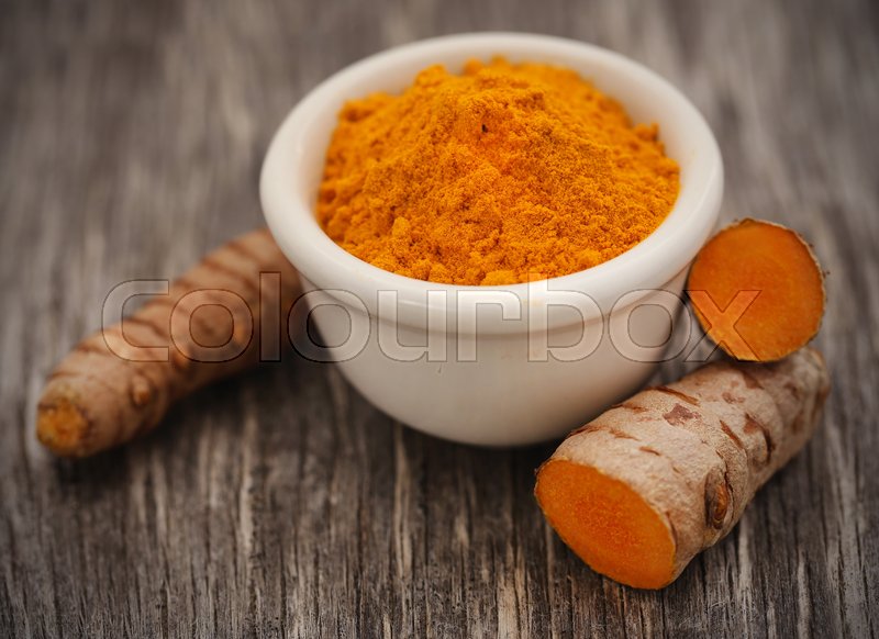 Raw turmeric with powder in a bowl on ... | Stock image | Colourbox