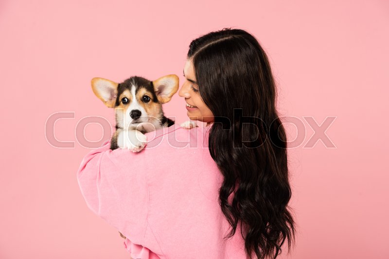 Happy young woman holding Welsh Corgi ... | Stock image | Colourbox