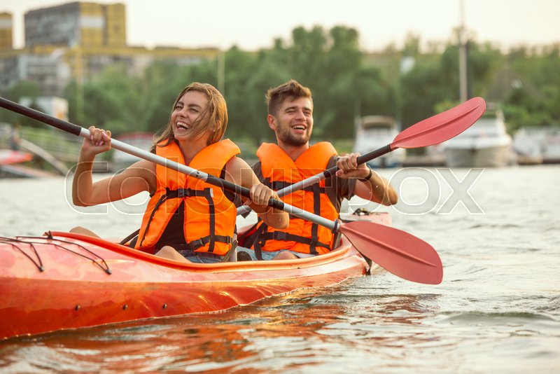 Happy young caucasian couple kayaking ... | Stock image | Colourbox