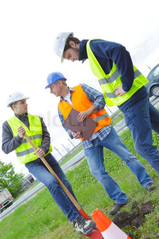 Workers talking around the cone | Stock image | Colourbox