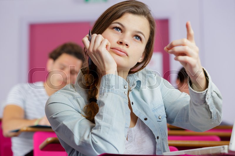 Student pointing on the board | Stock image | Colourbox