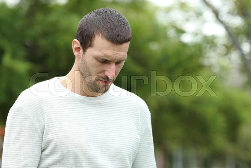 Sad man walking alone looking down in a ... | Stock image | Colourbox