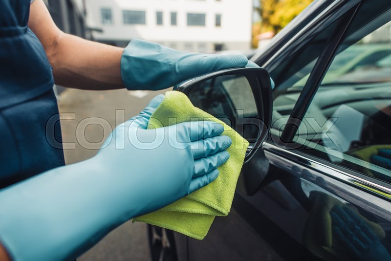 Cropped view of car cleaner wiping side ... | Stock image | Colourbox