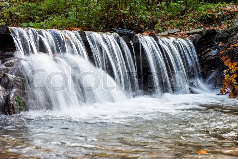 Autumn waterfall with yellow trees ... - Stock Image - Everypixel