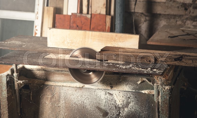 Carpentry machine with a piece of wood. | Stock image | Colourbox