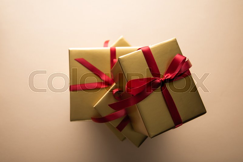 Top view of golden gift boxes with red ... | Stock image | Colourbox