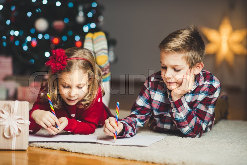 Two happy children writing letter at ... | Stock image | Colourbox