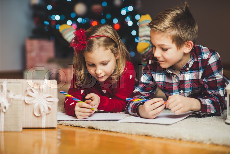 Two happy children writing letter at ... | Stock image | Colourbox