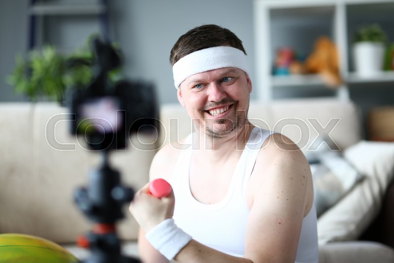Smiling Fitness Trainer Record Exercise ... | Stock image | Colourbox