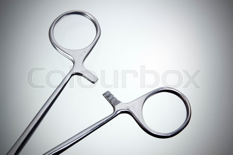 Metal surgical instrument on a gray ... | Stock image | Colourbox